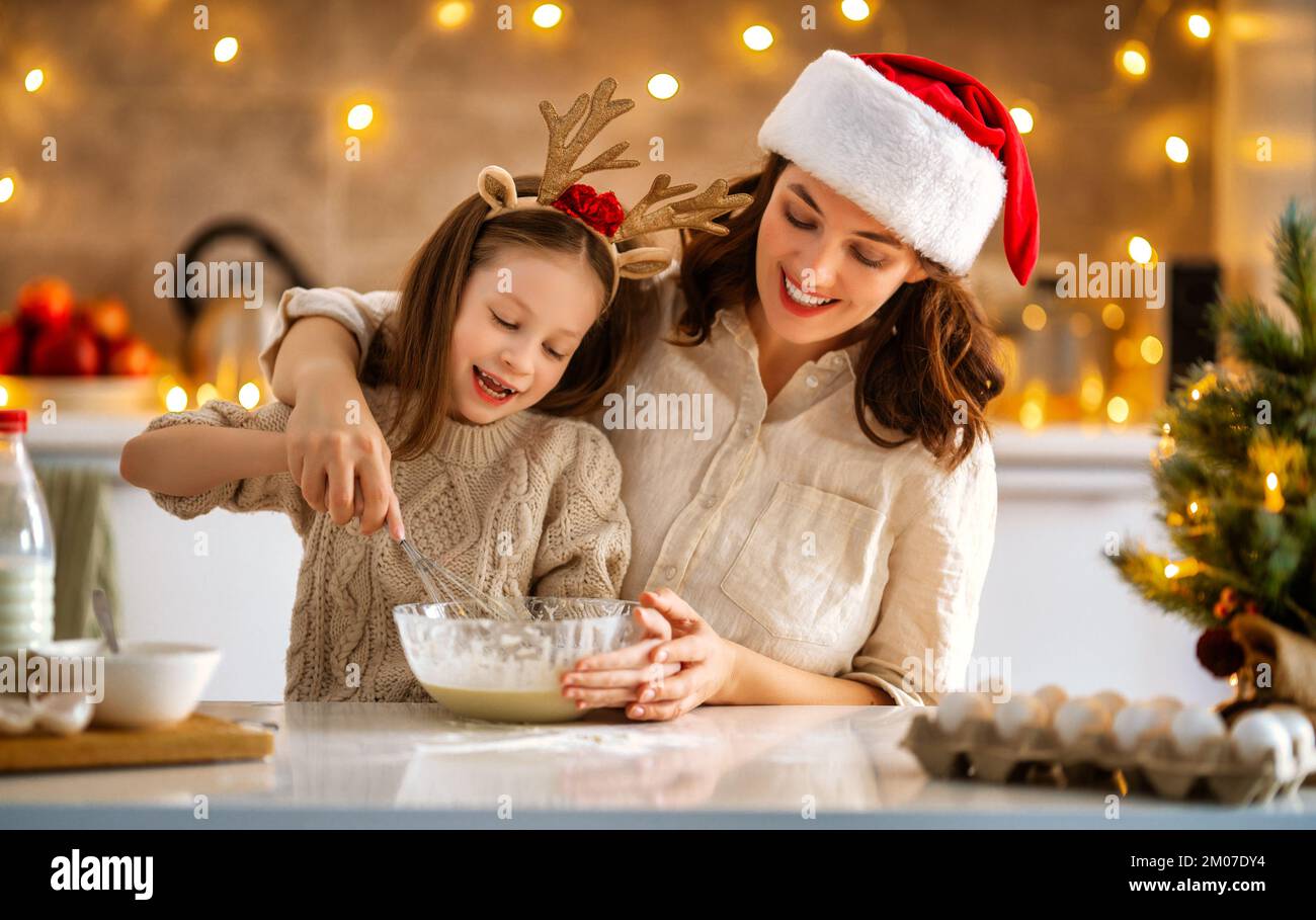 Merry Christmas and Happy Holidays. Family preparation holiday food ...