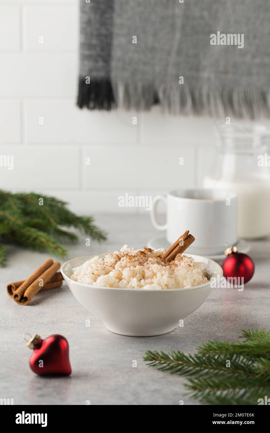 Scandinavian rice porridge with cinnamon in a bowl surrounded by ...