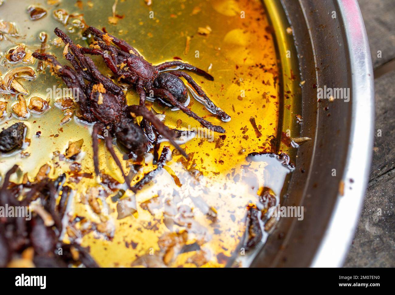 Udong, Cambodia. 19th Nov, 2022. Two fried tarantulas in golden oil at ...