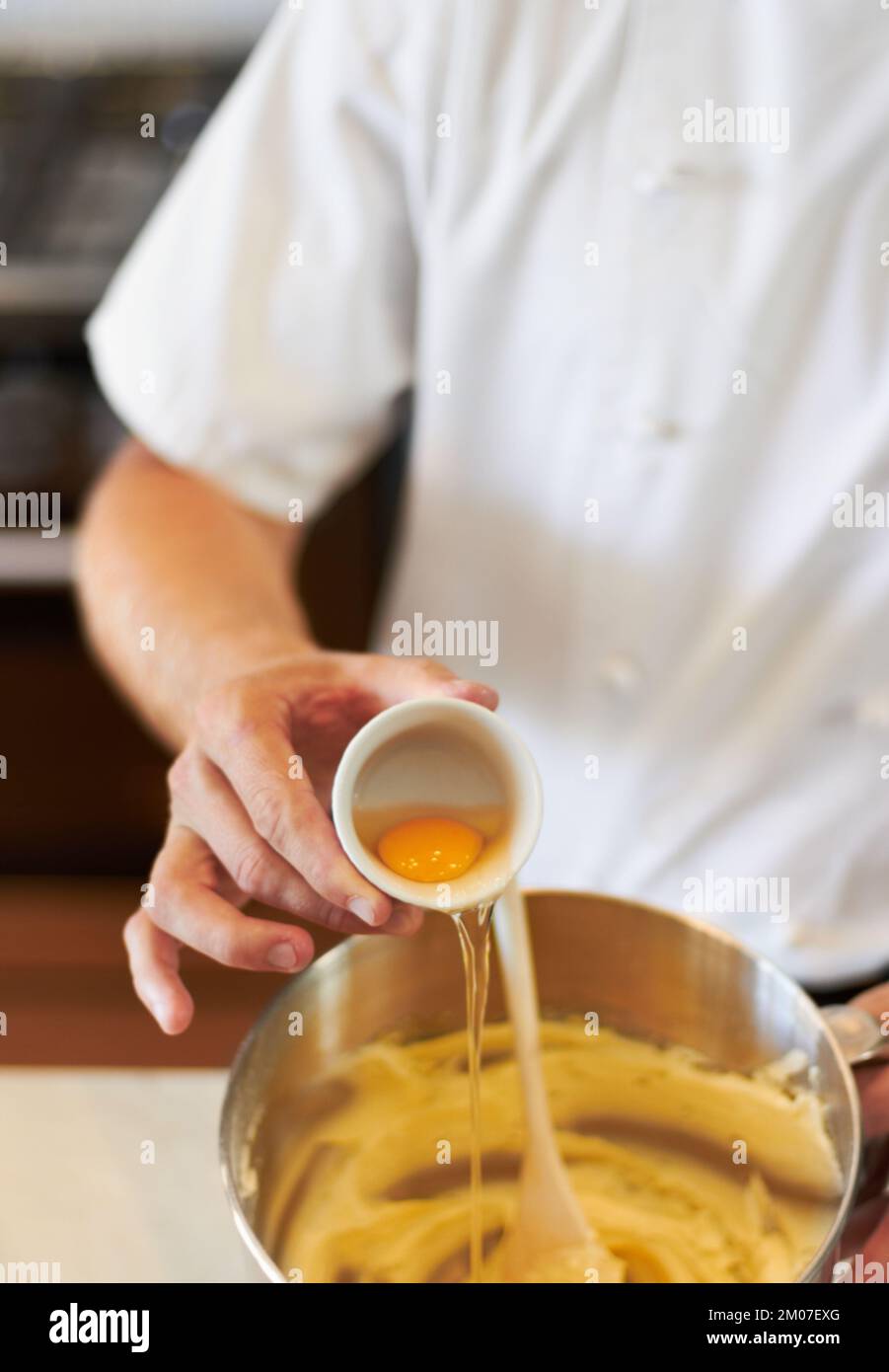 Getting the right measurements for the perfect result. A baker putting ...