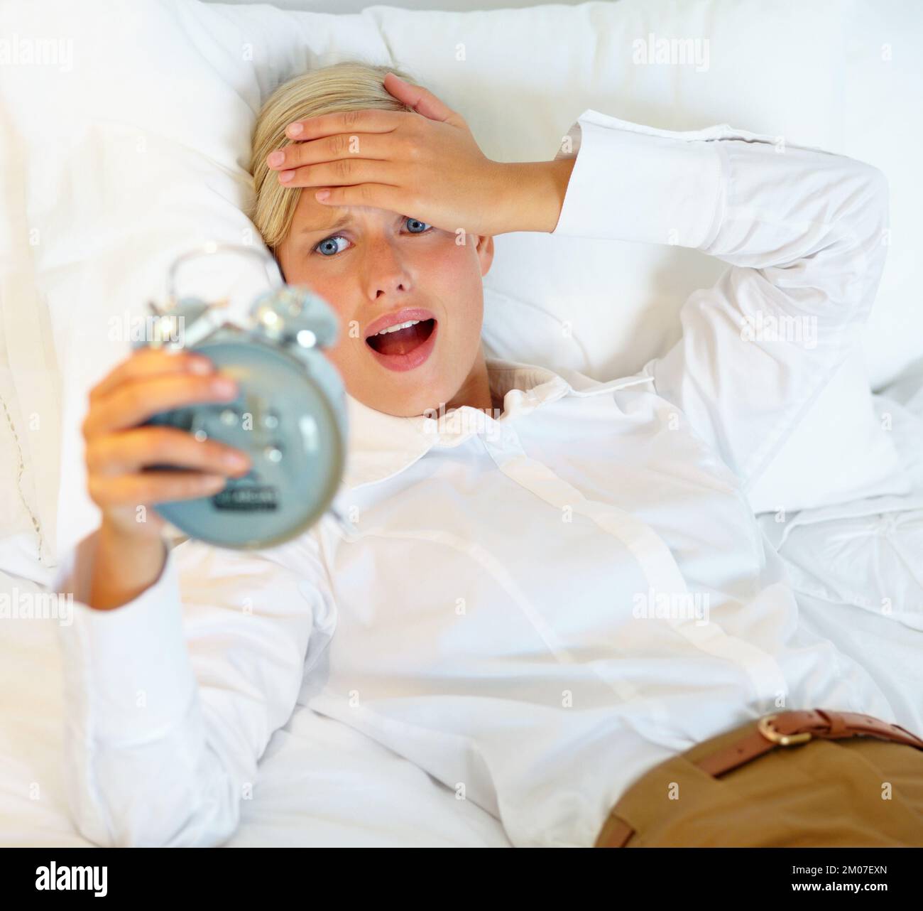 Young women looking alarm clock shock hi-res stock photography and ...