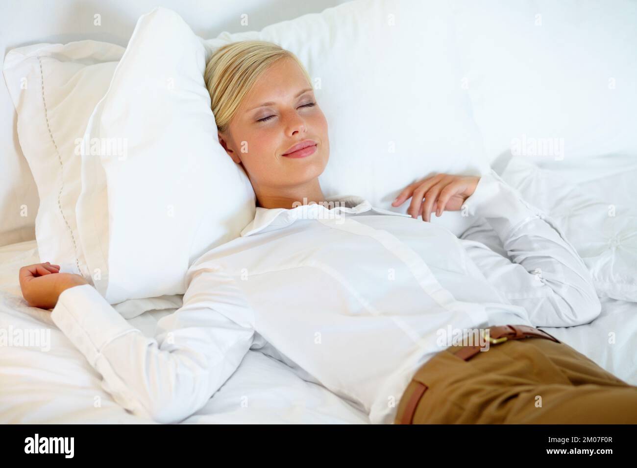 Blissfully asleep after a long day at the office. A young businesswoman ...