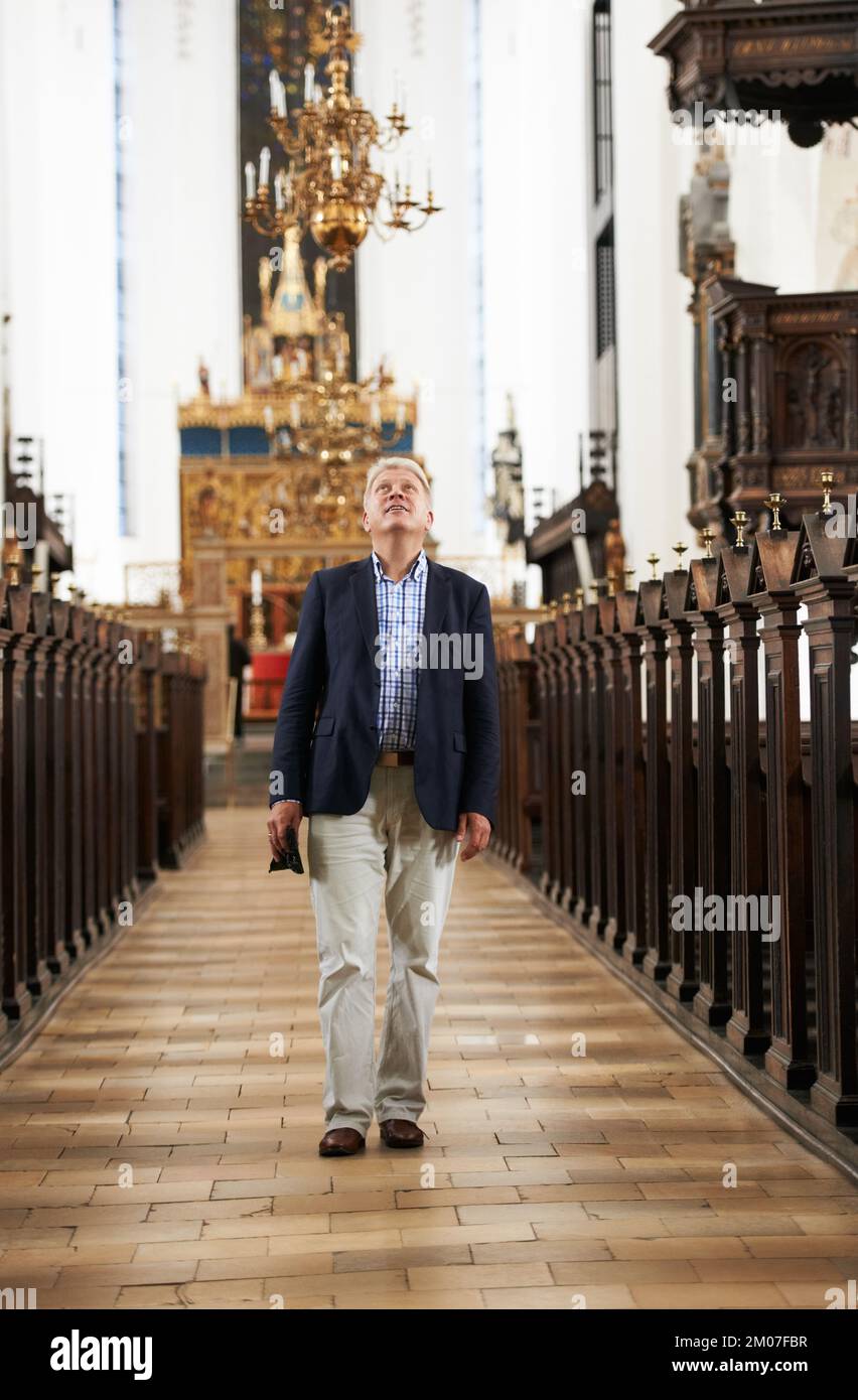 Looking to God. A senior man walking down the aisle of a church Stock ...