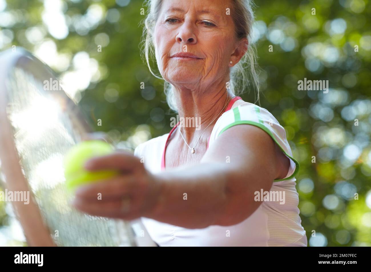 Getting ready to play. Senior woman getting ready to serve - Tennis ...