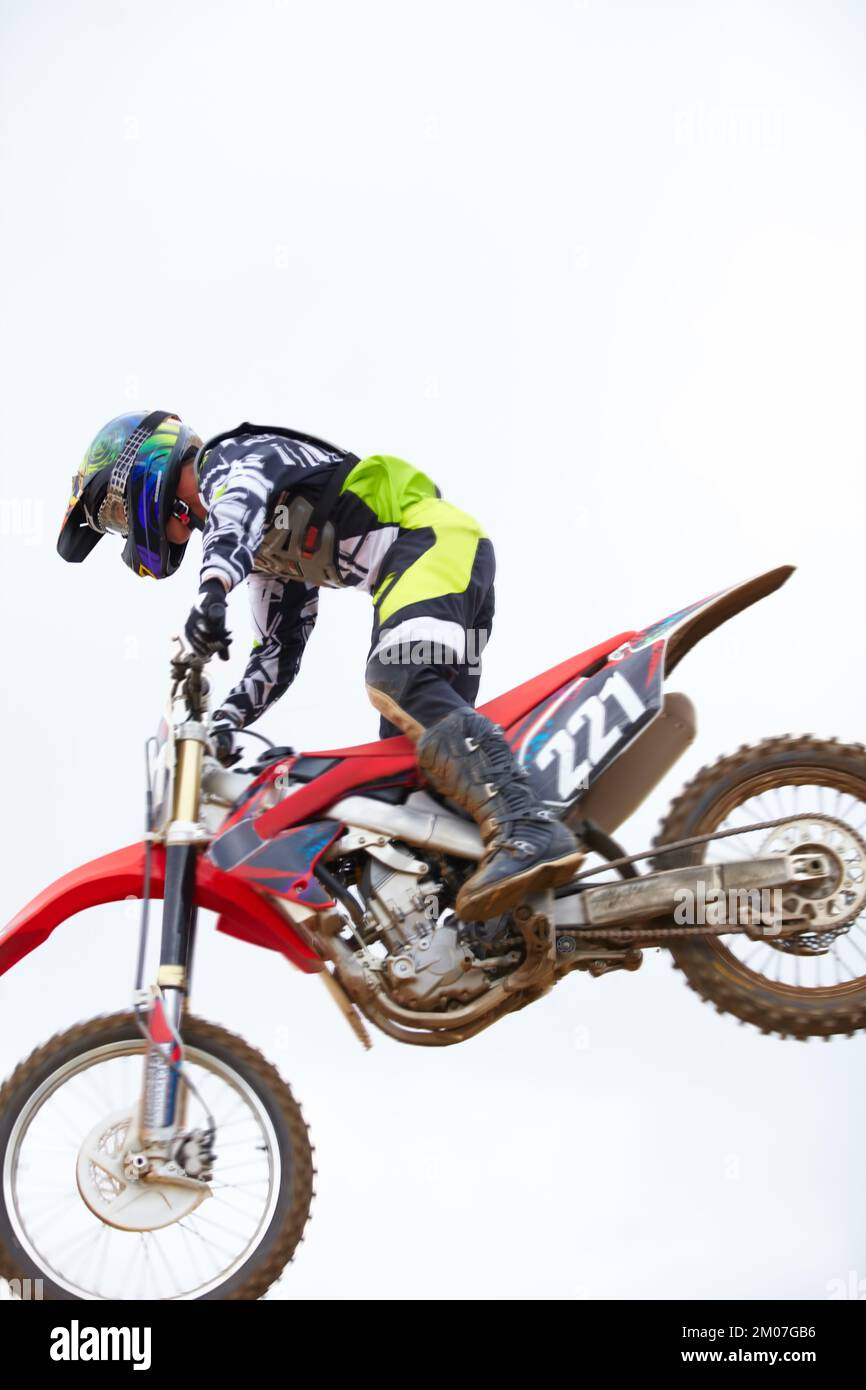 Pleasing the crowd with a little risk-taking. A motocross rider mid-air ...