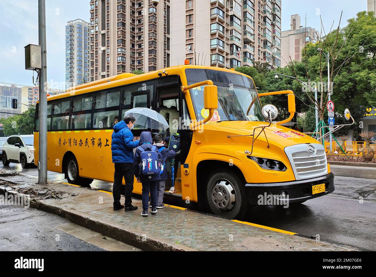 SHANGHAI, CHINA - DECEMBER 5, 2022 - A school bus of a private primary school picks up students ...