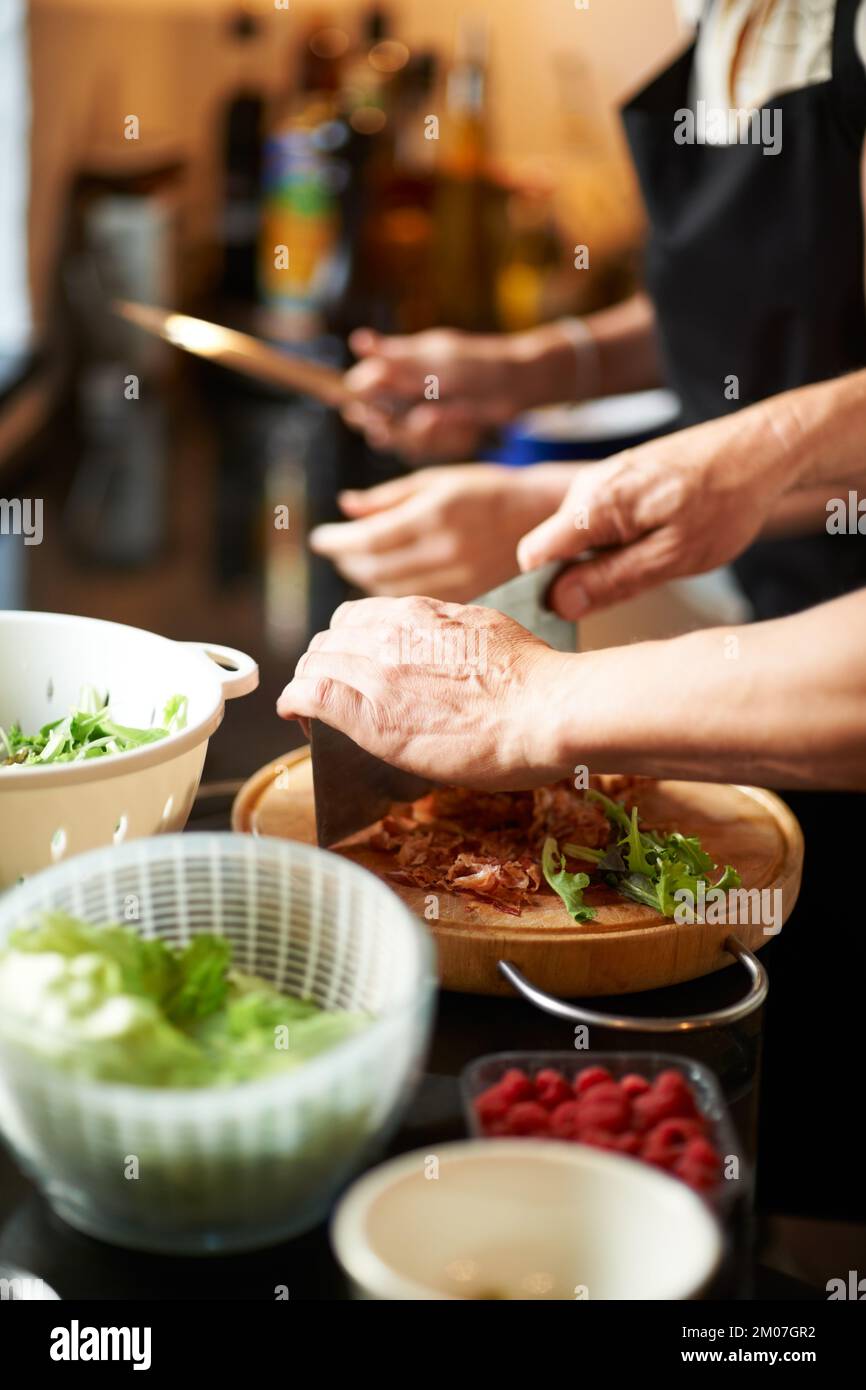 Cooking up a storm. a couple cooking in the kitchen Stock Photo - Alamy