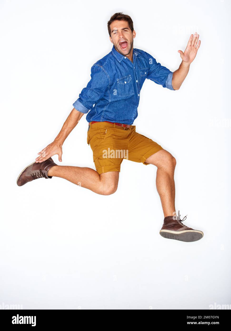 Yeah. Stylish young guy jumping and against a white background Stock ...