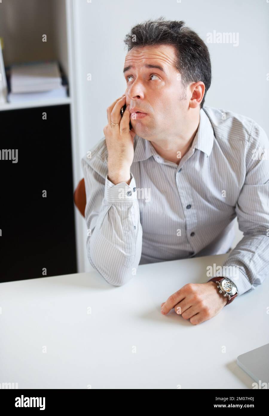 This day has gone on forever...a bored-looking office worker eagerly ...