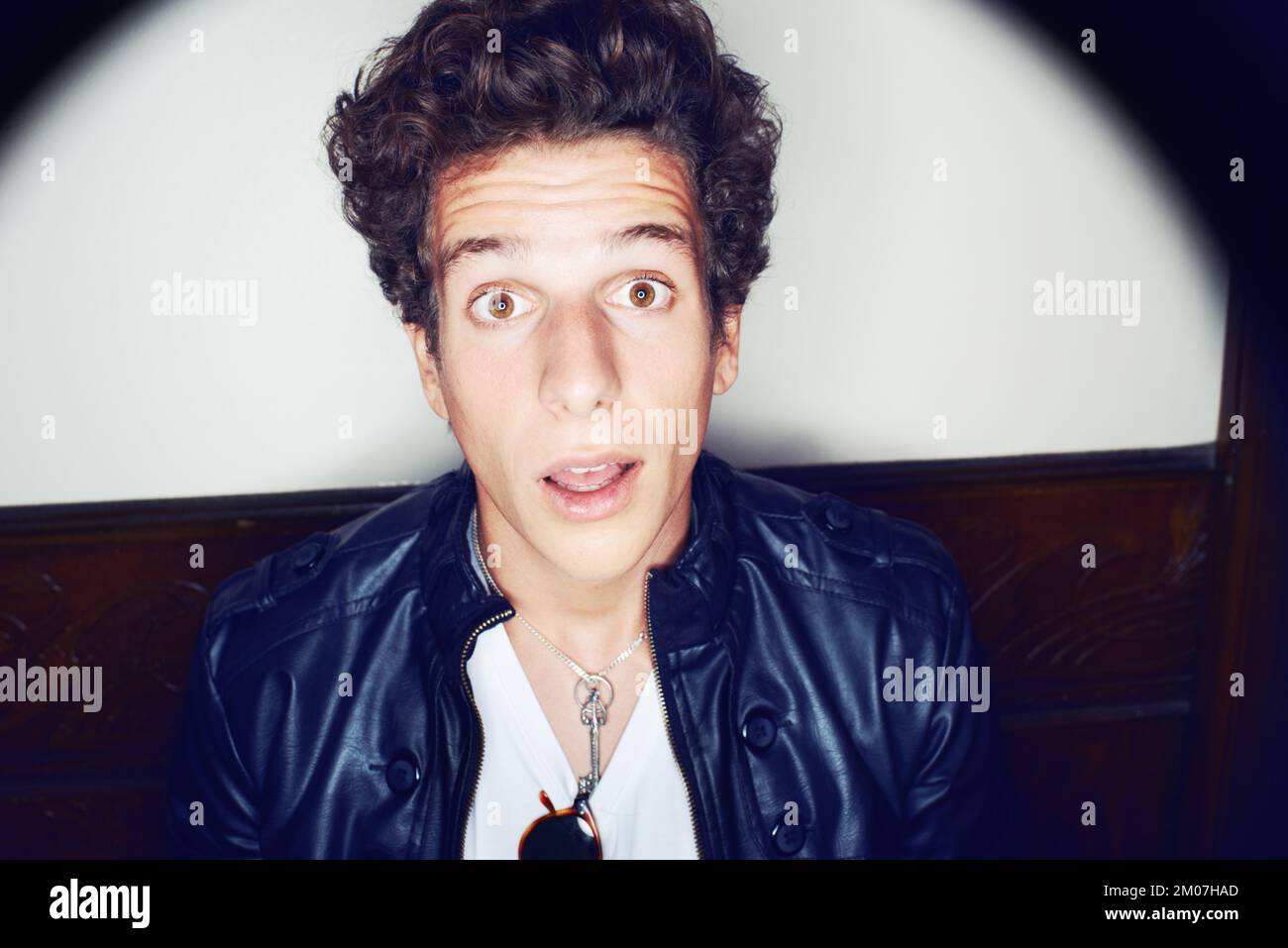 Huh. Portrait of a wide-eyed young man surrounded by a halo of light ...