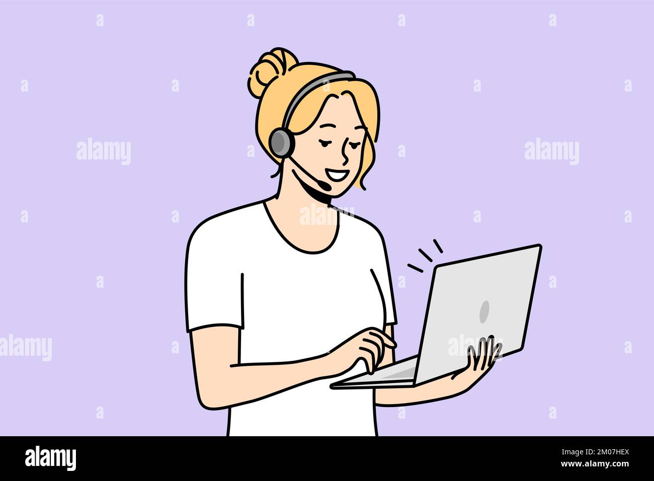 Young woman in headset holds laptop, communicates with colleagues or ...