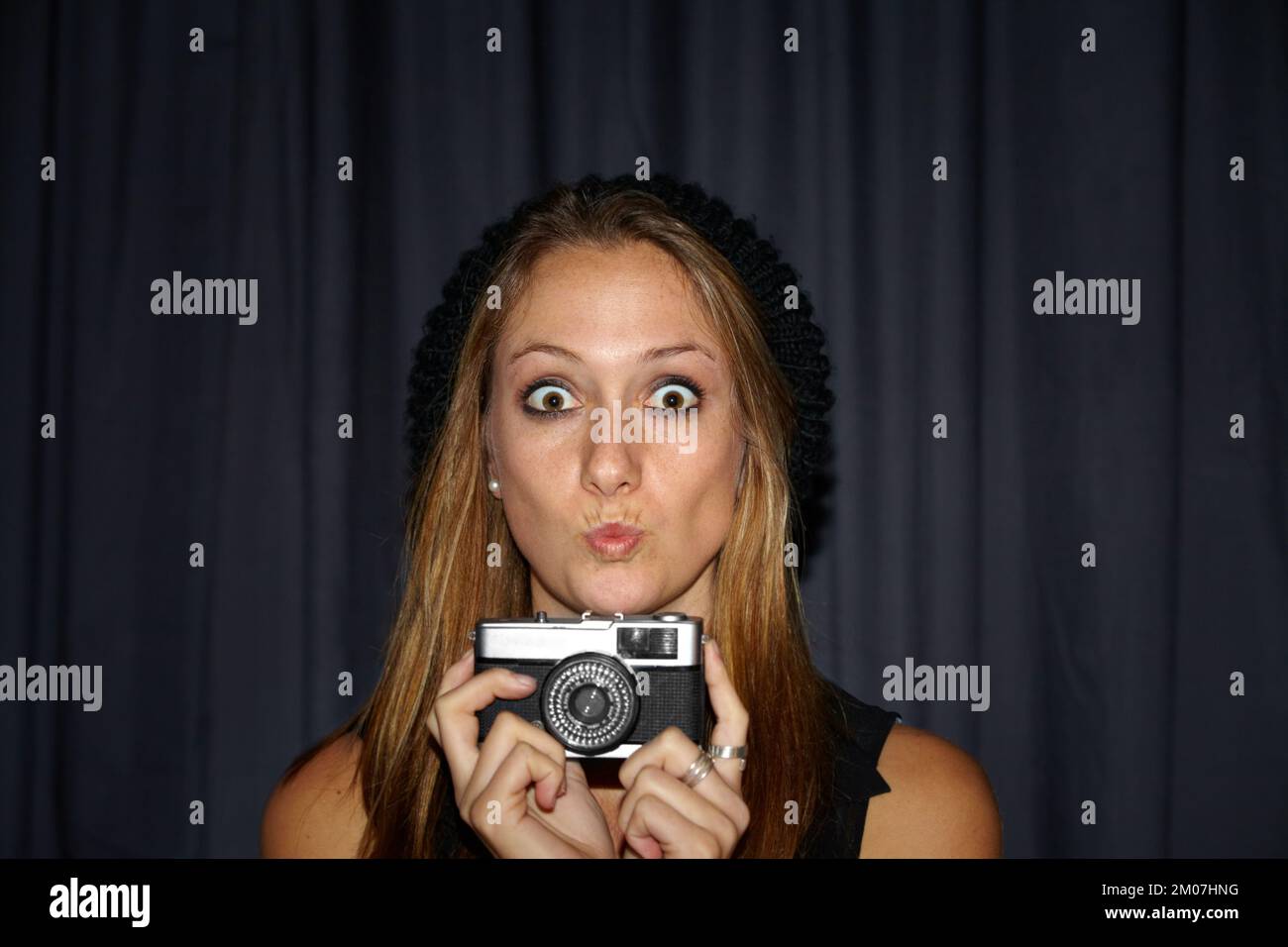 Wide-eyed style. Portrait of a young woman making a strange face and ...