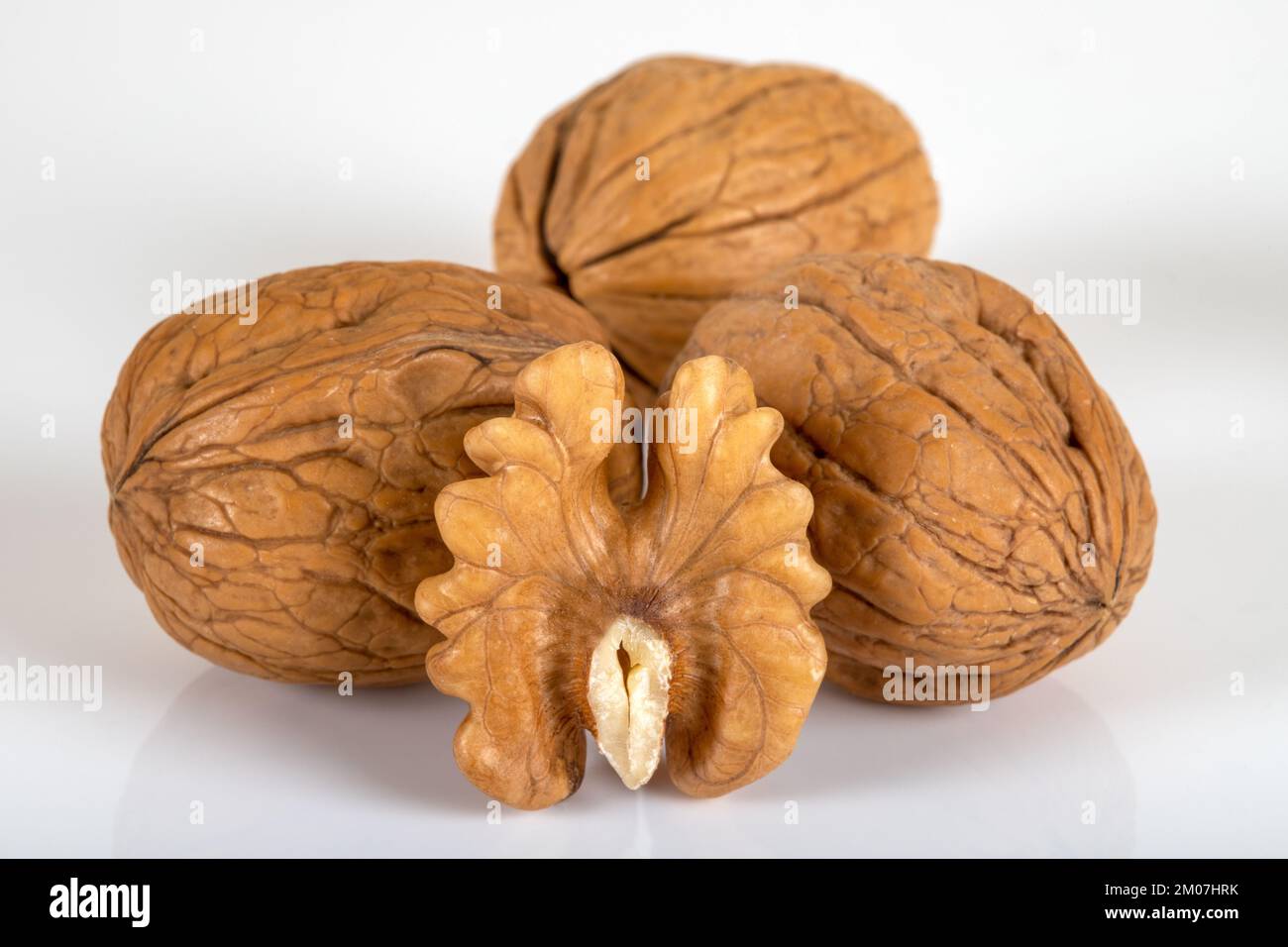 Cracked walnuts and whole walnuts on white background Stock Photo - Alamy