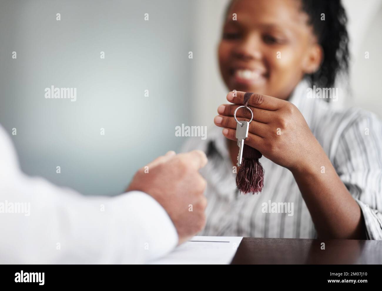 Enjoy your stay, sir. Closeup of a receptionist handing over the hotel ...
