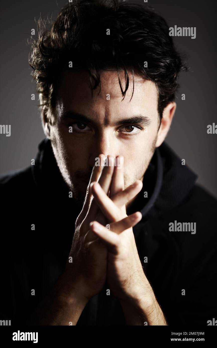 Concentrating deeply on his prayer. Portrait of a young man deep in ...