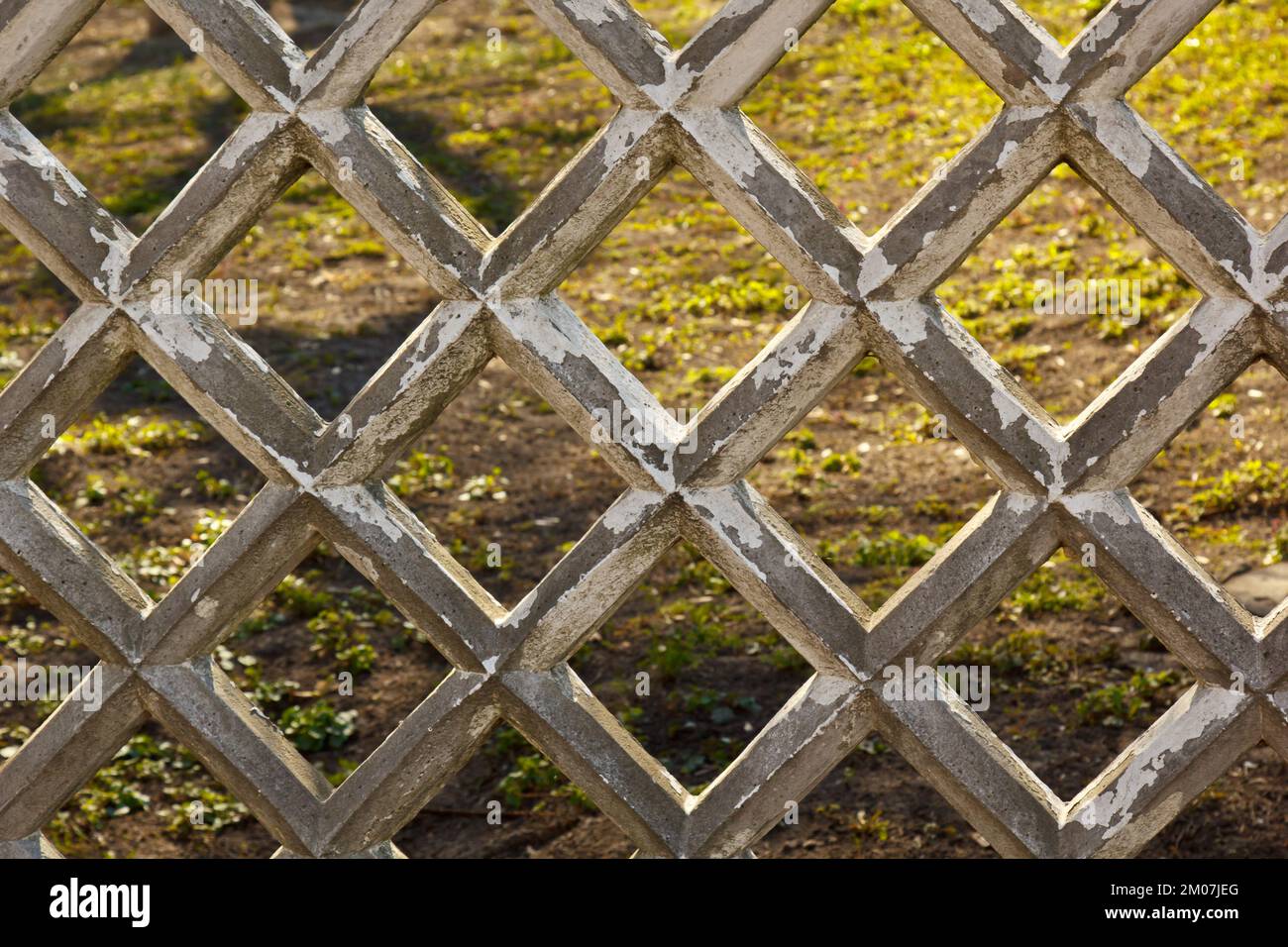 diamond shaped concrete fence close-up on a dark background. structure ...
