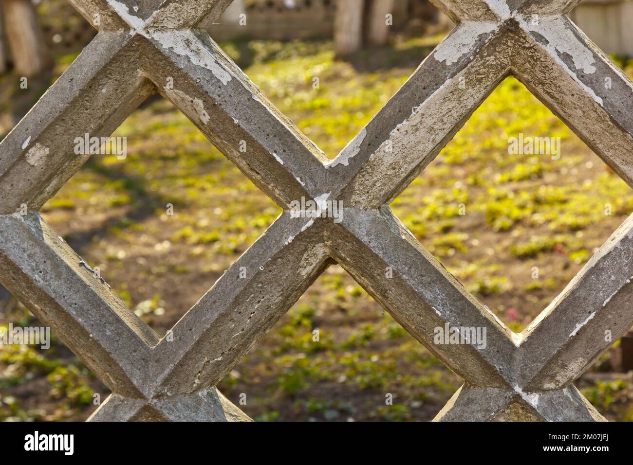 diamond shaped concrete fence close-up on a dark background. structure ...