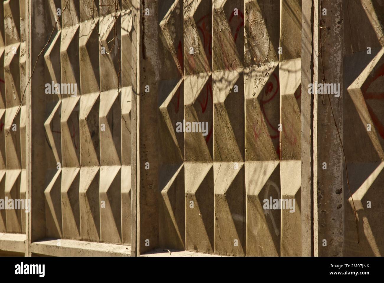 diamond shaped concrete fence close-up on a dark background. structure ...