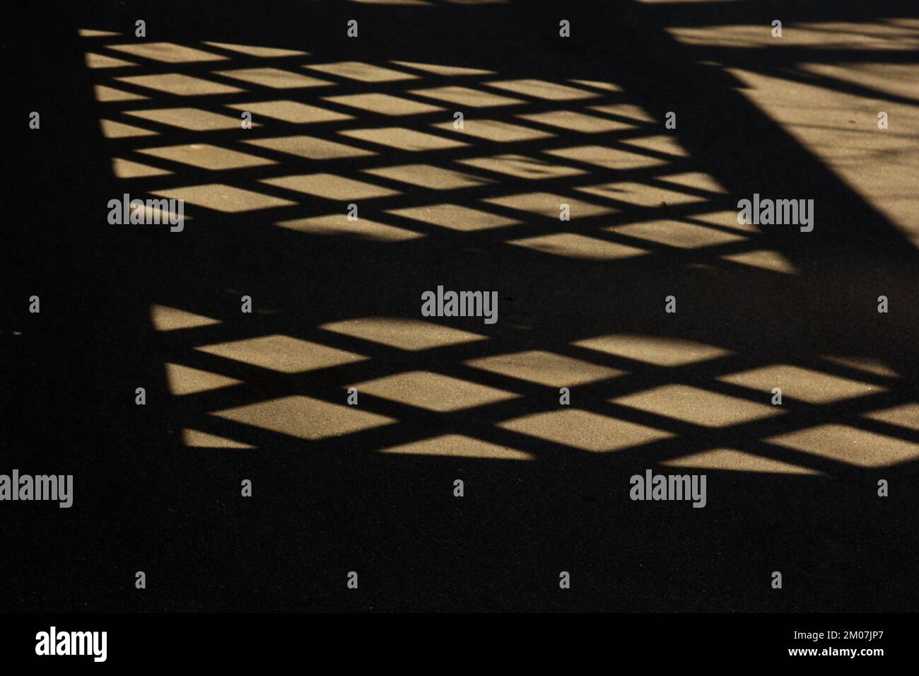 geometric shadows from the grid on the ground. view from above ...