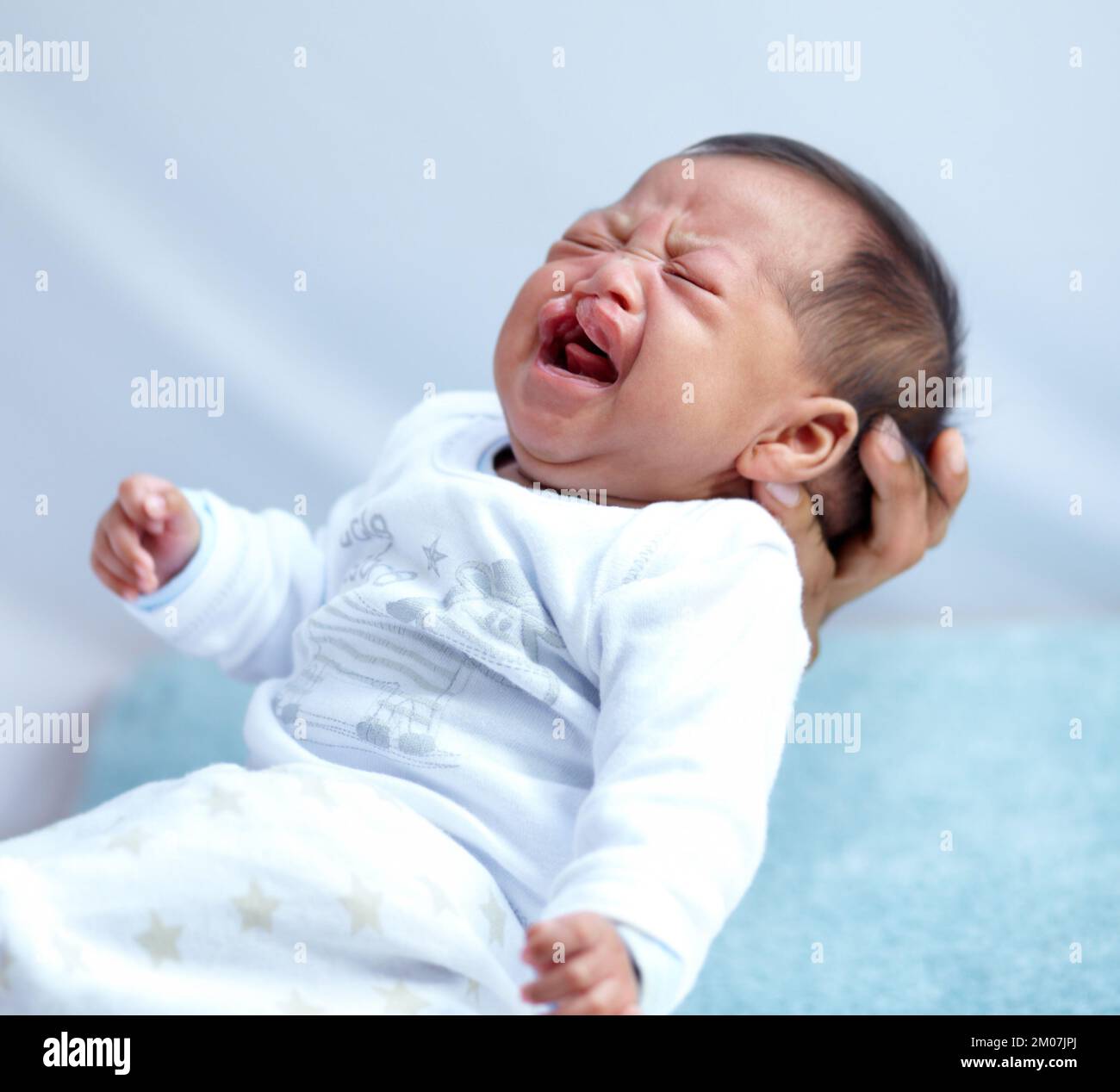 Maybe baby needs a change. A baby girl with a cleft palate being held ...