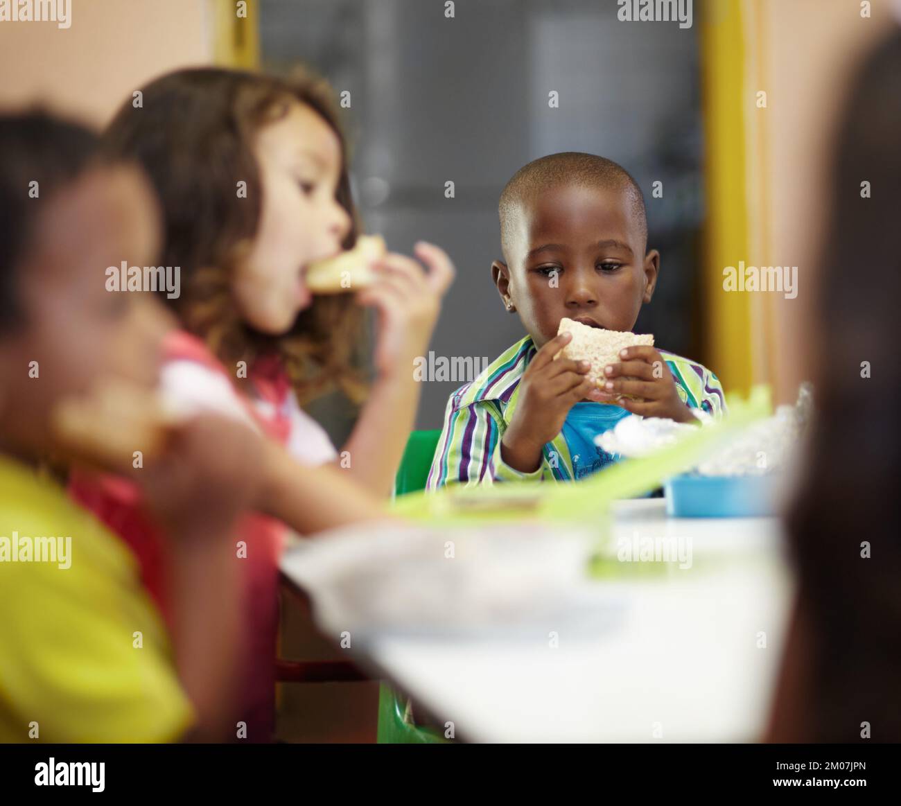 Enjoying a nutritious lunch. Pre-school children on their lunch break ...