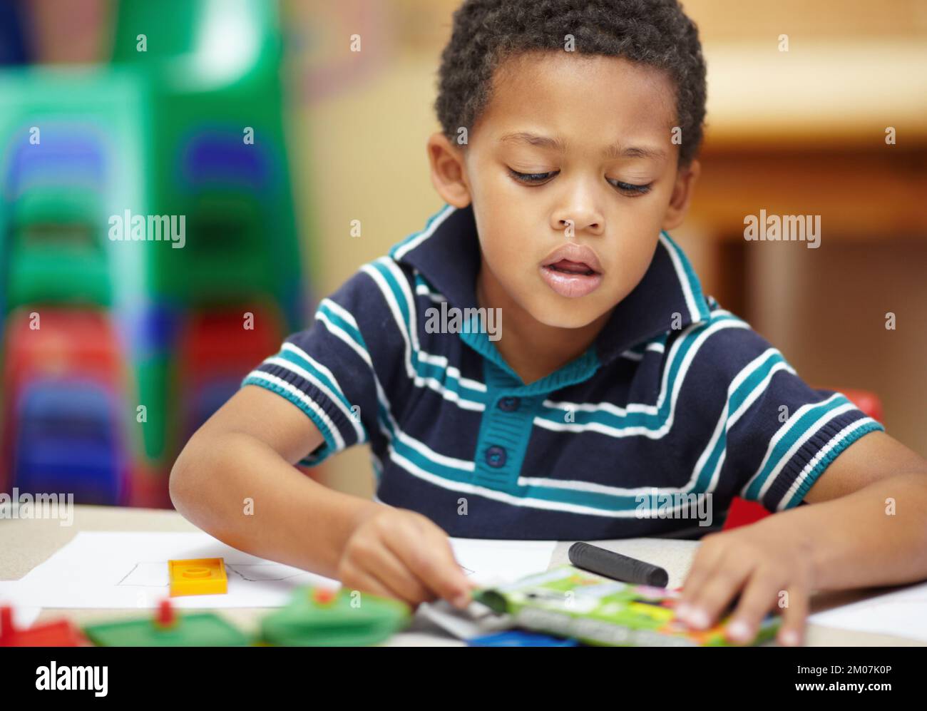 Expanding his creativity. Pre-school african american boy concentrating ...