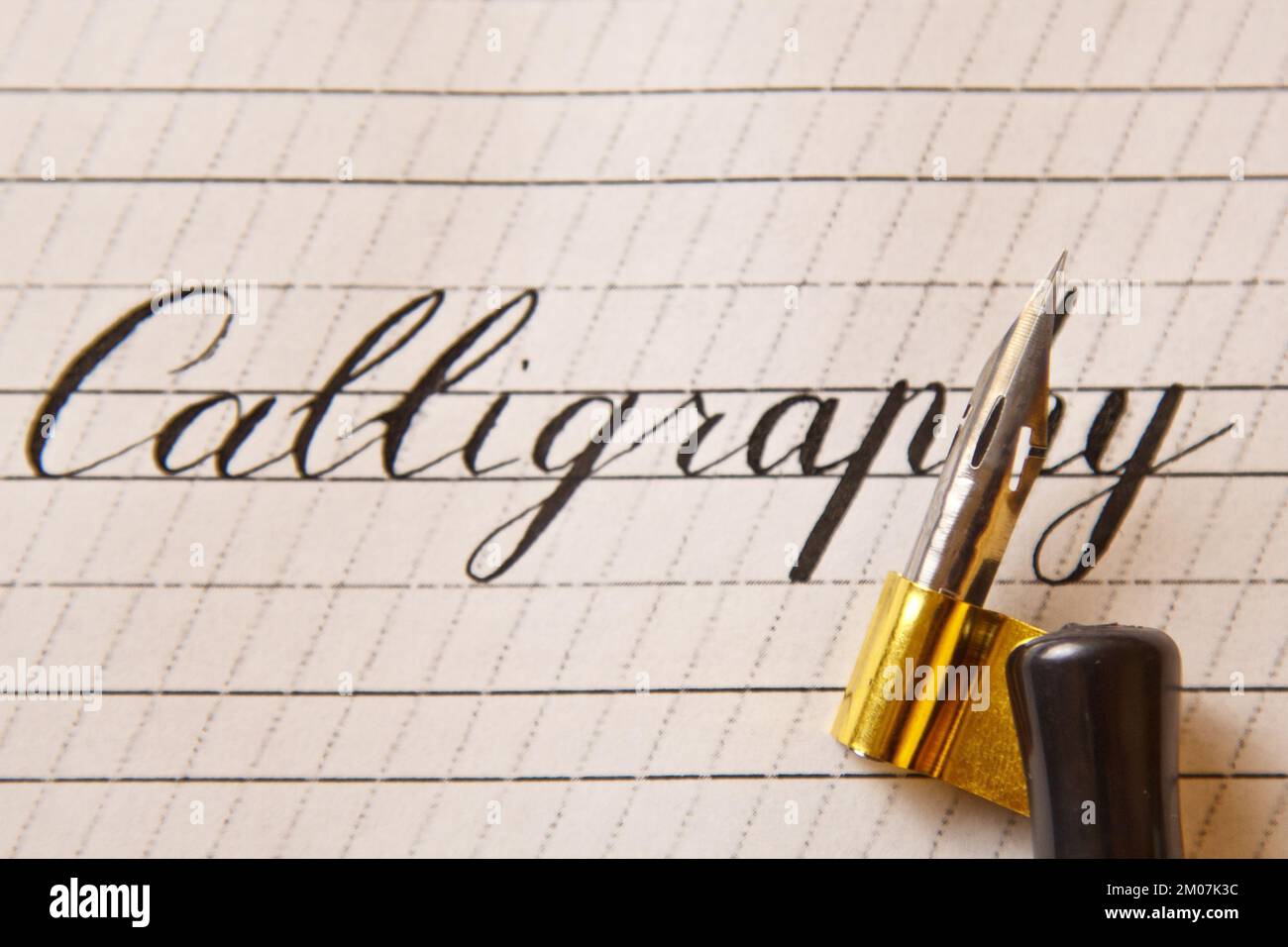 word calligraphy is written with an ink pen on a white paper sheet with ...