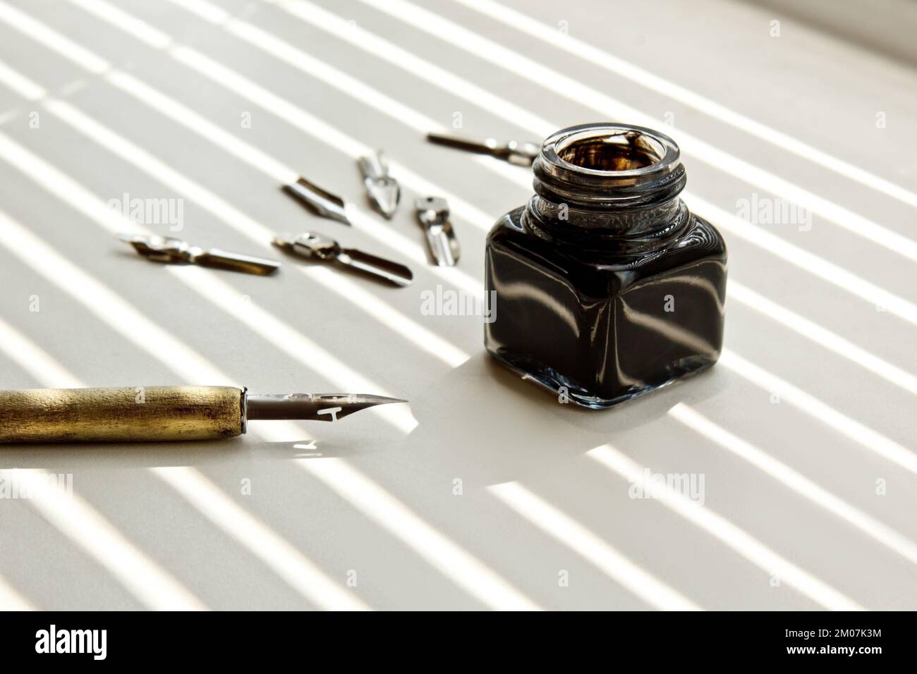 Inkpot with metal tips for the ink pen on a white background in solar ...