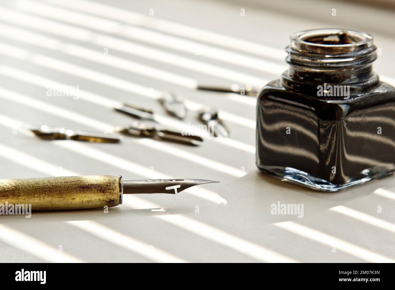 Inkpot with metal tips for the ink pen on a white background in solar ...