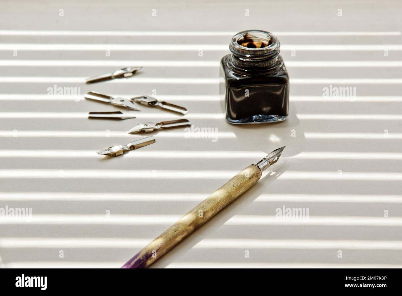 Inkpot with metal tips for the ink pen on a white background in solar ...