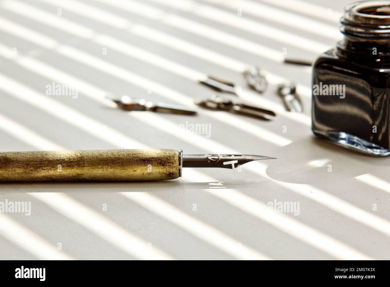 Inkpot with metal tips for the ink pen on a white background in solar ...