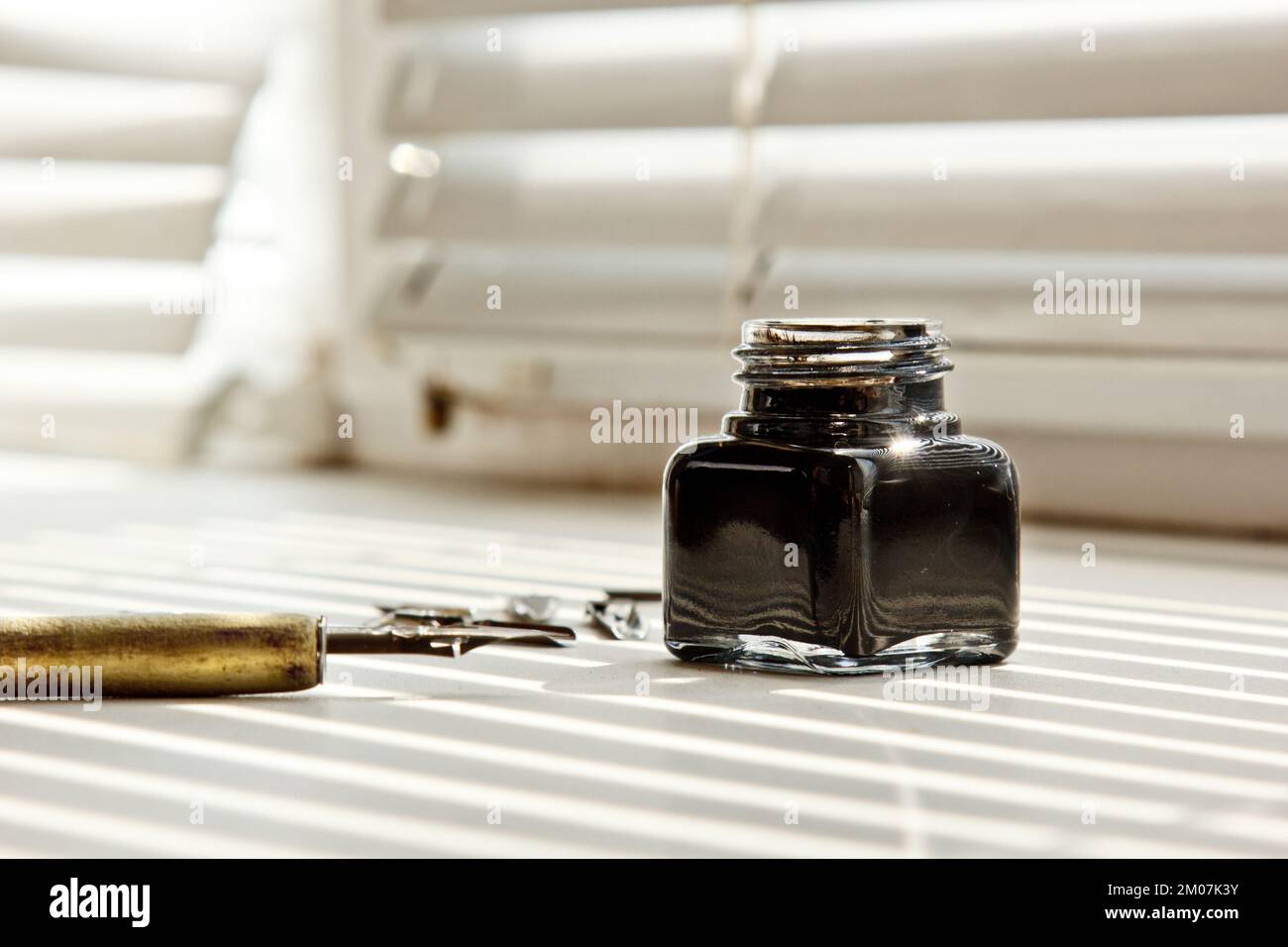 Inkpot with metal tips for the ink pen on a white background in solar ...