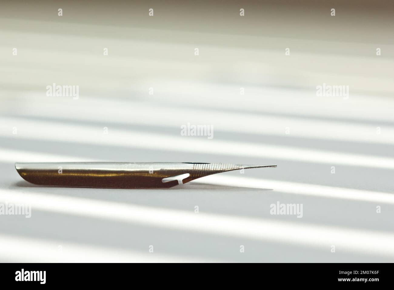 metal tip for the ink pen on a white background in solar rays ...