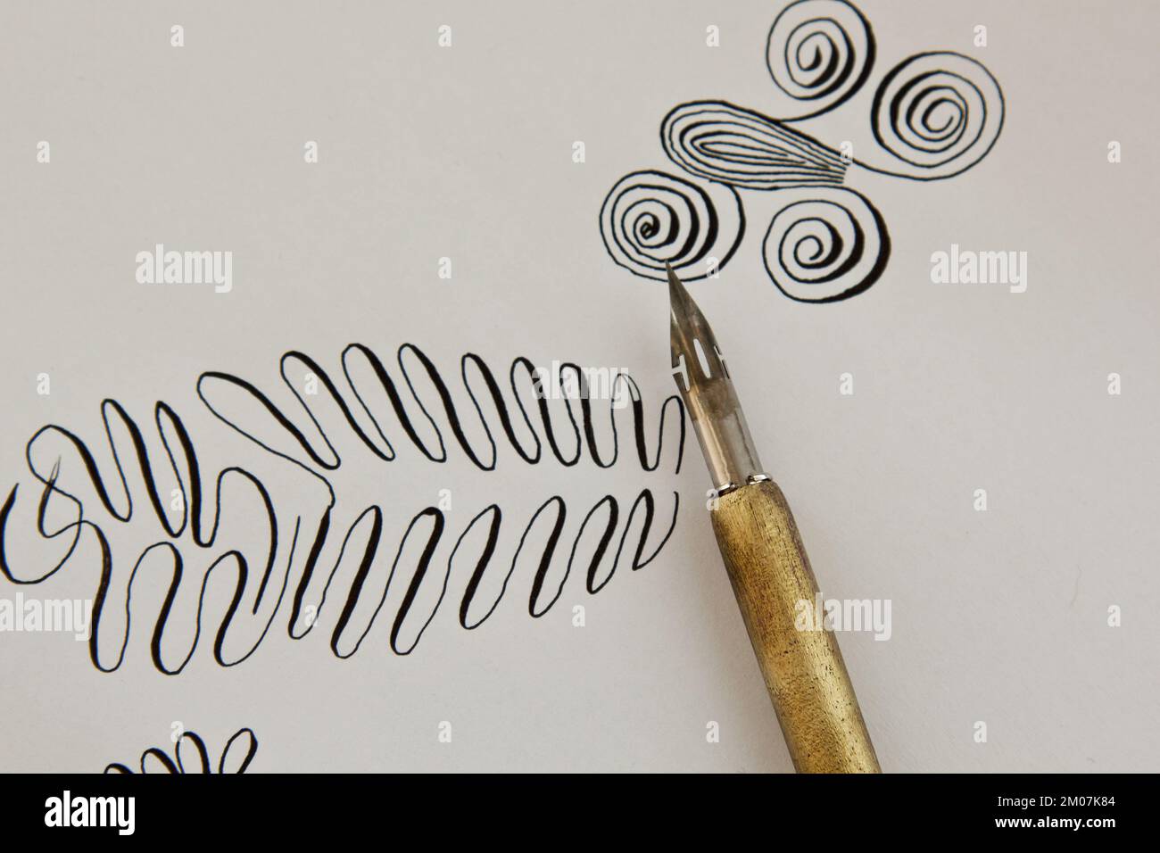 patterns drawn with an ink pen on a white paper sheet with stripes ...