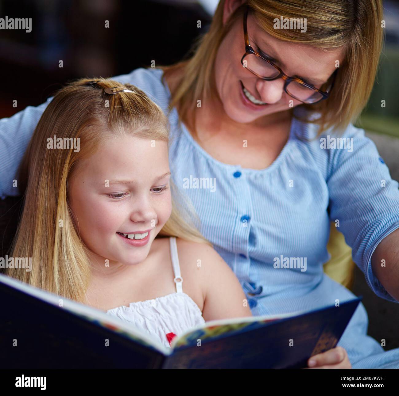 My favorite book. A cute young girl sitting next to her mother while ...
