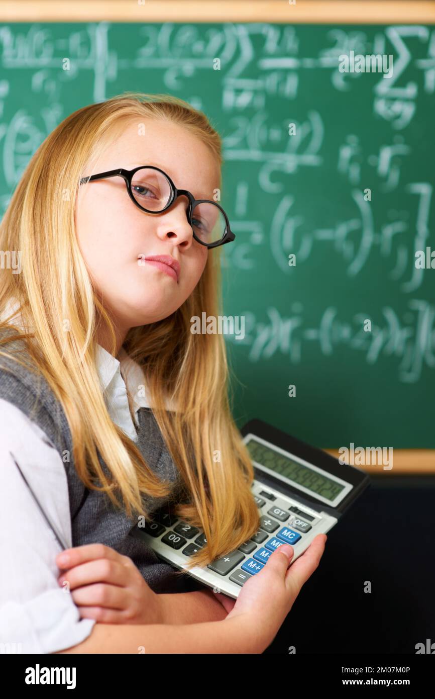Shes got all the answers. Portrait of a cute blonde girl holding a pen ...