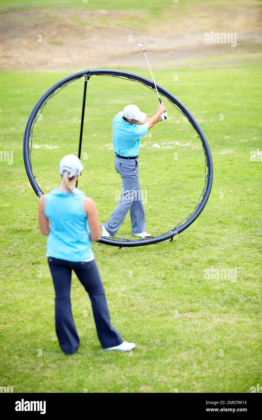 Your swing should stop when you get to here...Image of a male coach ...