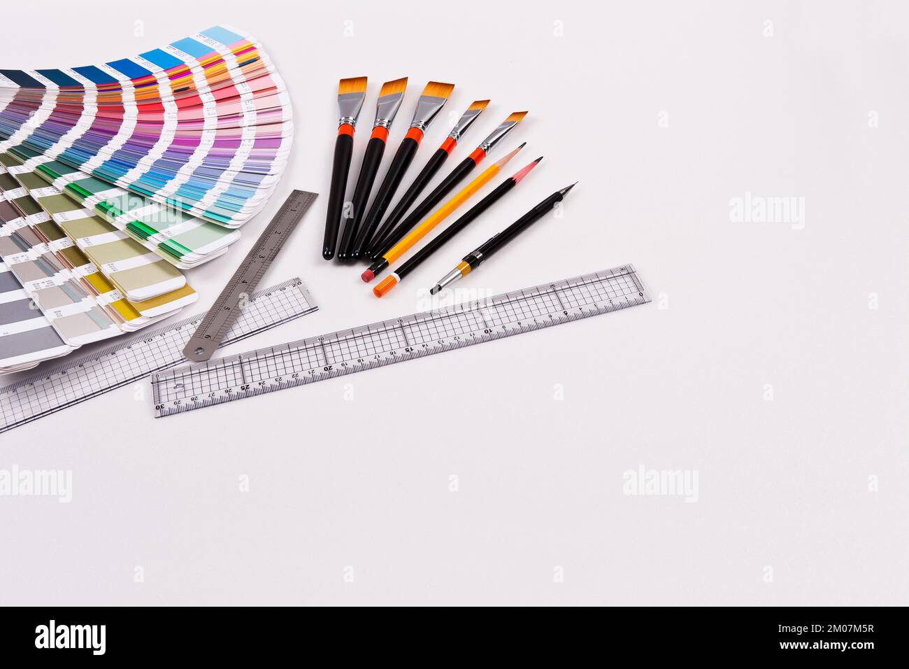 Various tools, such as color charts, brushes, rulers, and pencils, were ...