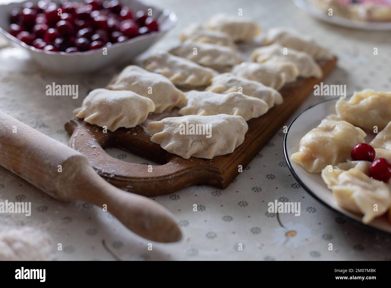 Homemade raw dumplings with cherries. Cooking at home Stock Photo - Alamy