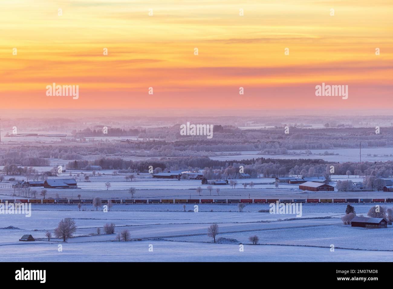 Freight train in a wintry landscape with a colorful sunset Stock Photo - Alamy