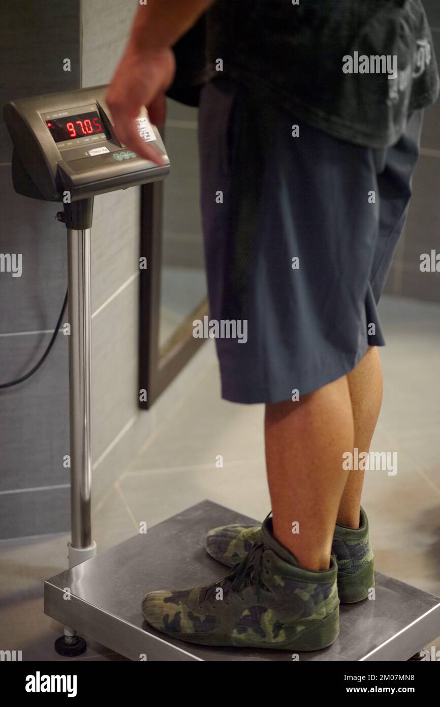 Keeping an eye on that weight gain. Cropped image of a bodybuilder ...