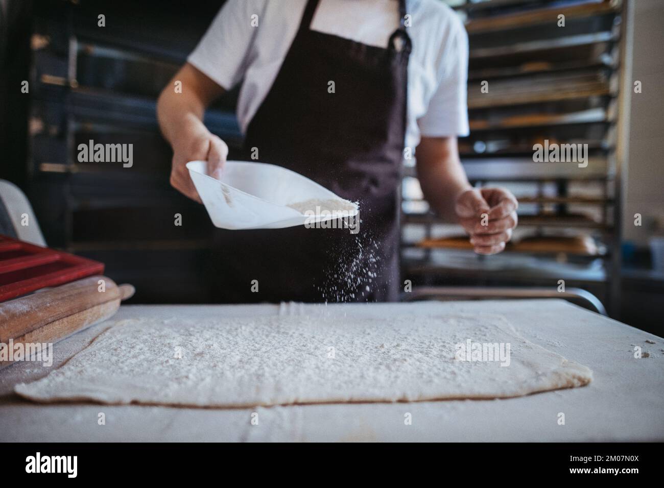 Close-up of young baker preparing pastries in bakery Stock Photo - Alamy