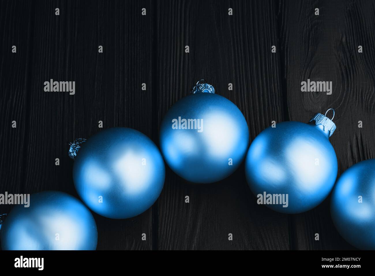 Colored christmas decorations on black wooden table. Xmas balls on ...