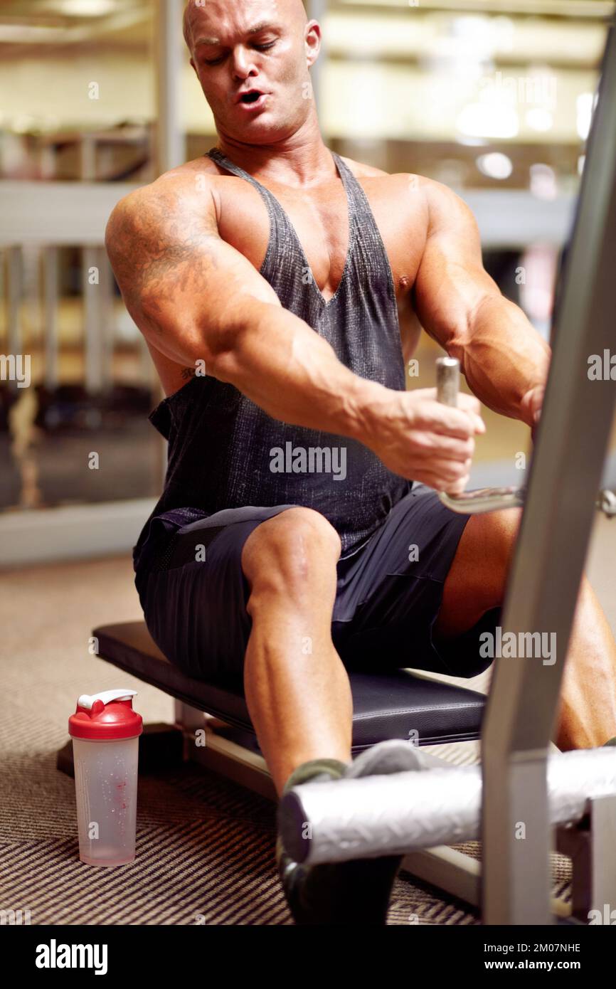 His determination never falters. a male bodybuilder using an exercise ...