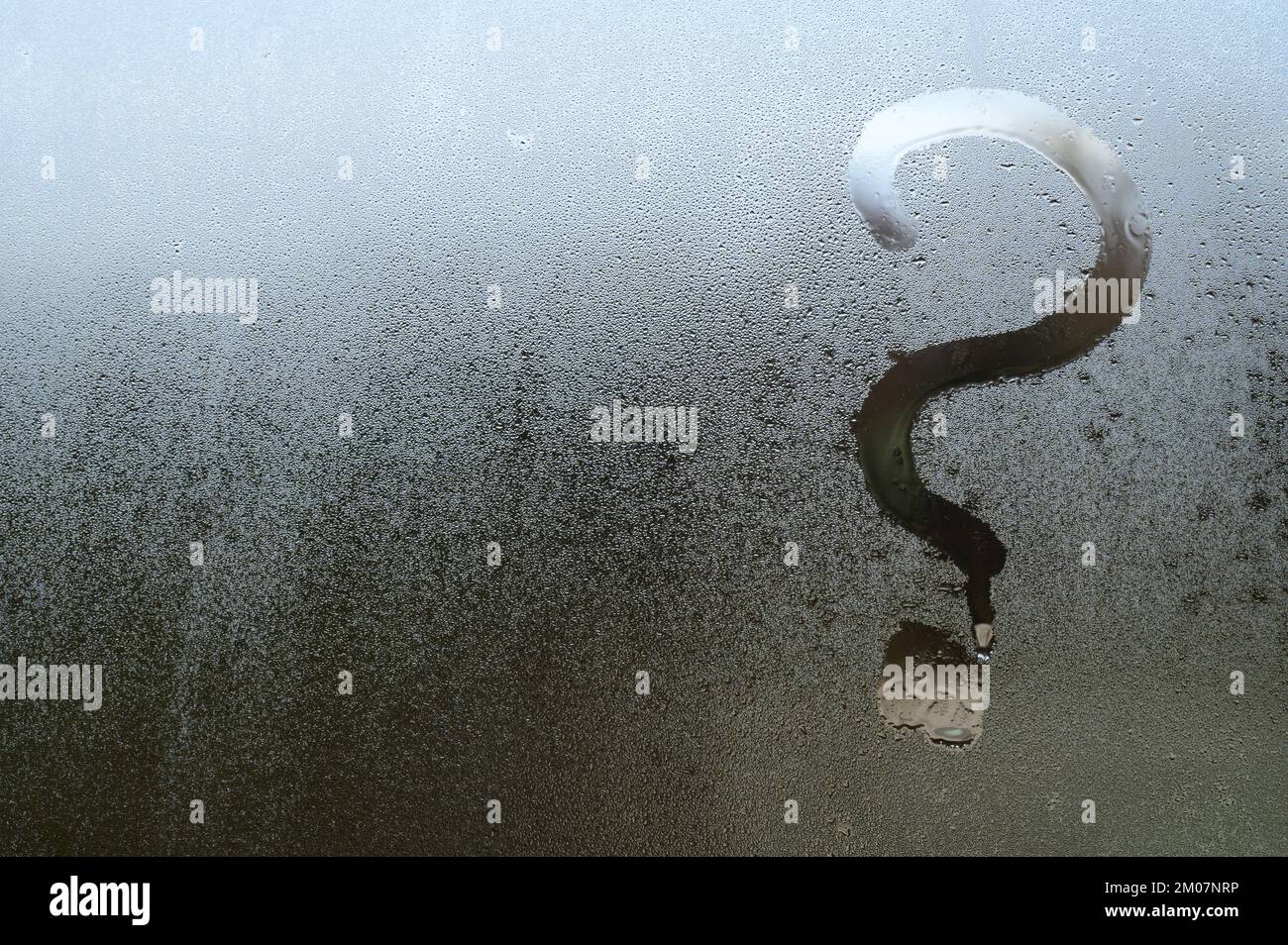 Fogged glass, a question mark is written on the window with ...