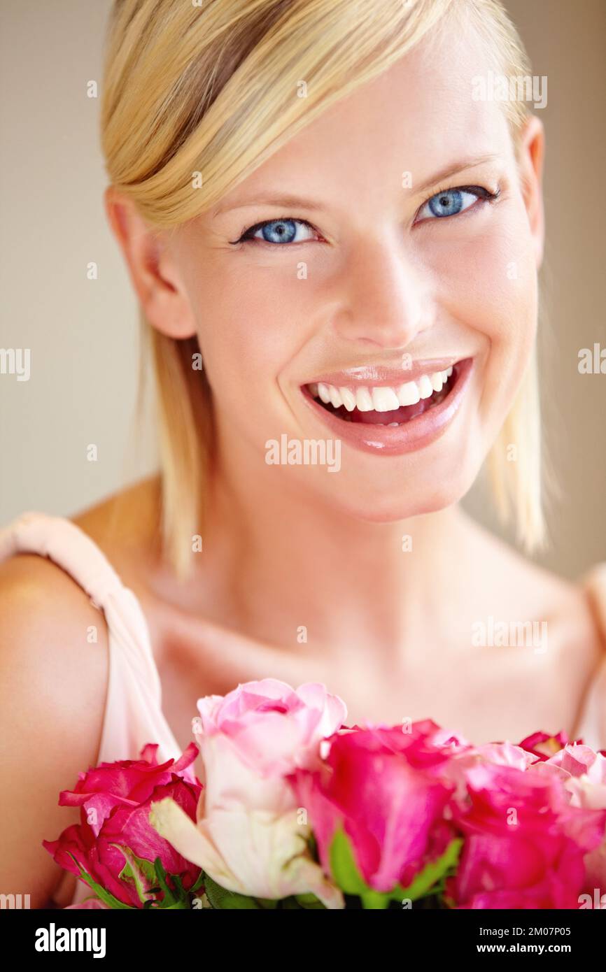 He remembered our anniversary. Portrait of a young woman holding a ...