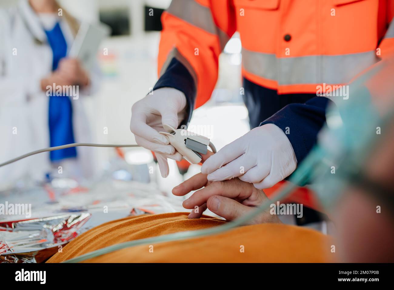 Close-up of rescuers taking care of patient from ambulance, giving him ...