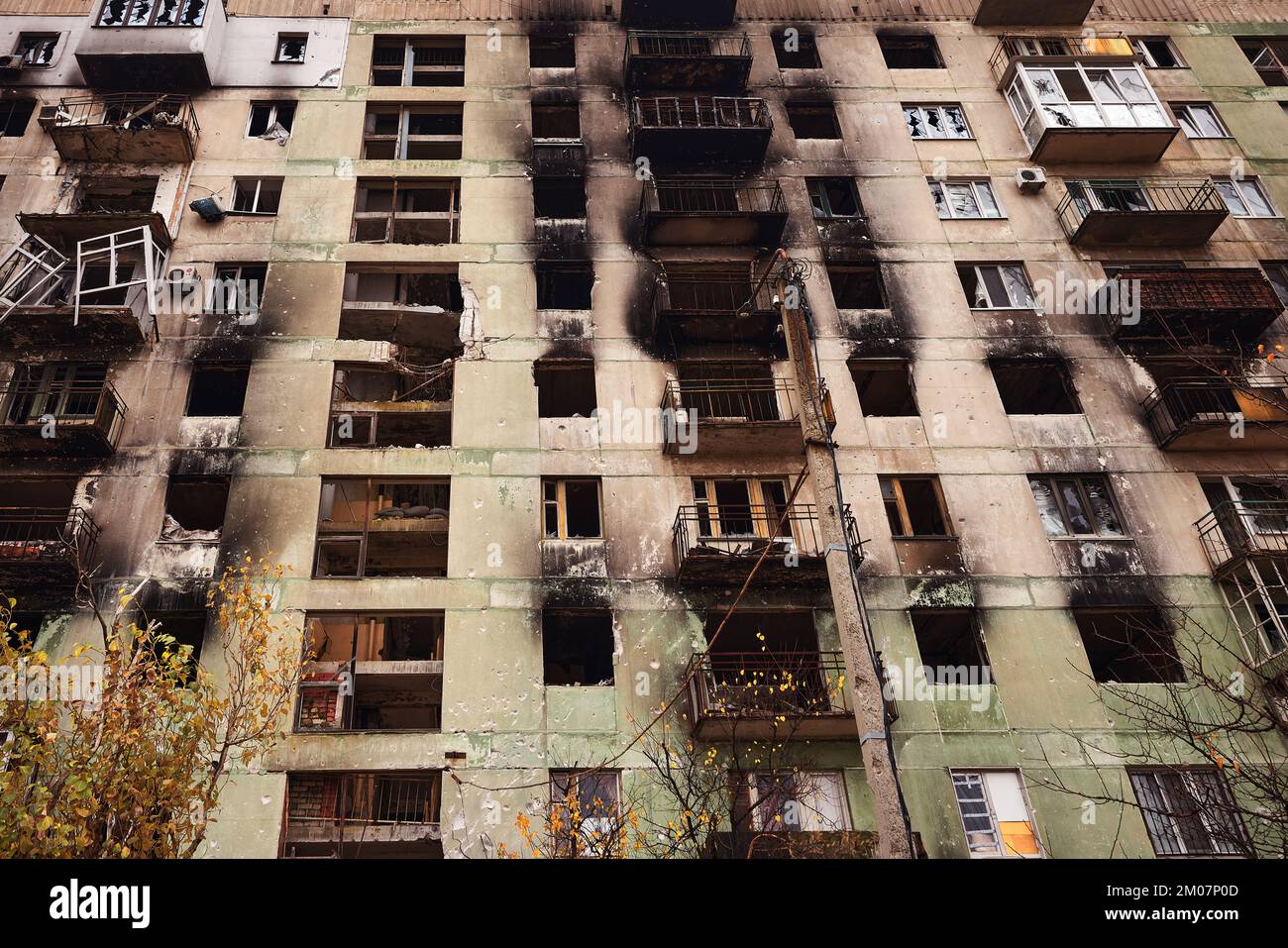 A burnt-out high-rise in the war zone. Damage to a residential building ...