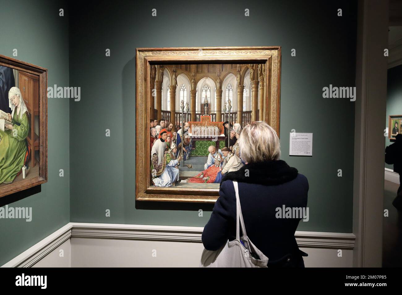 A woman studying a painting by Netherlandish painter Rogier van der ...