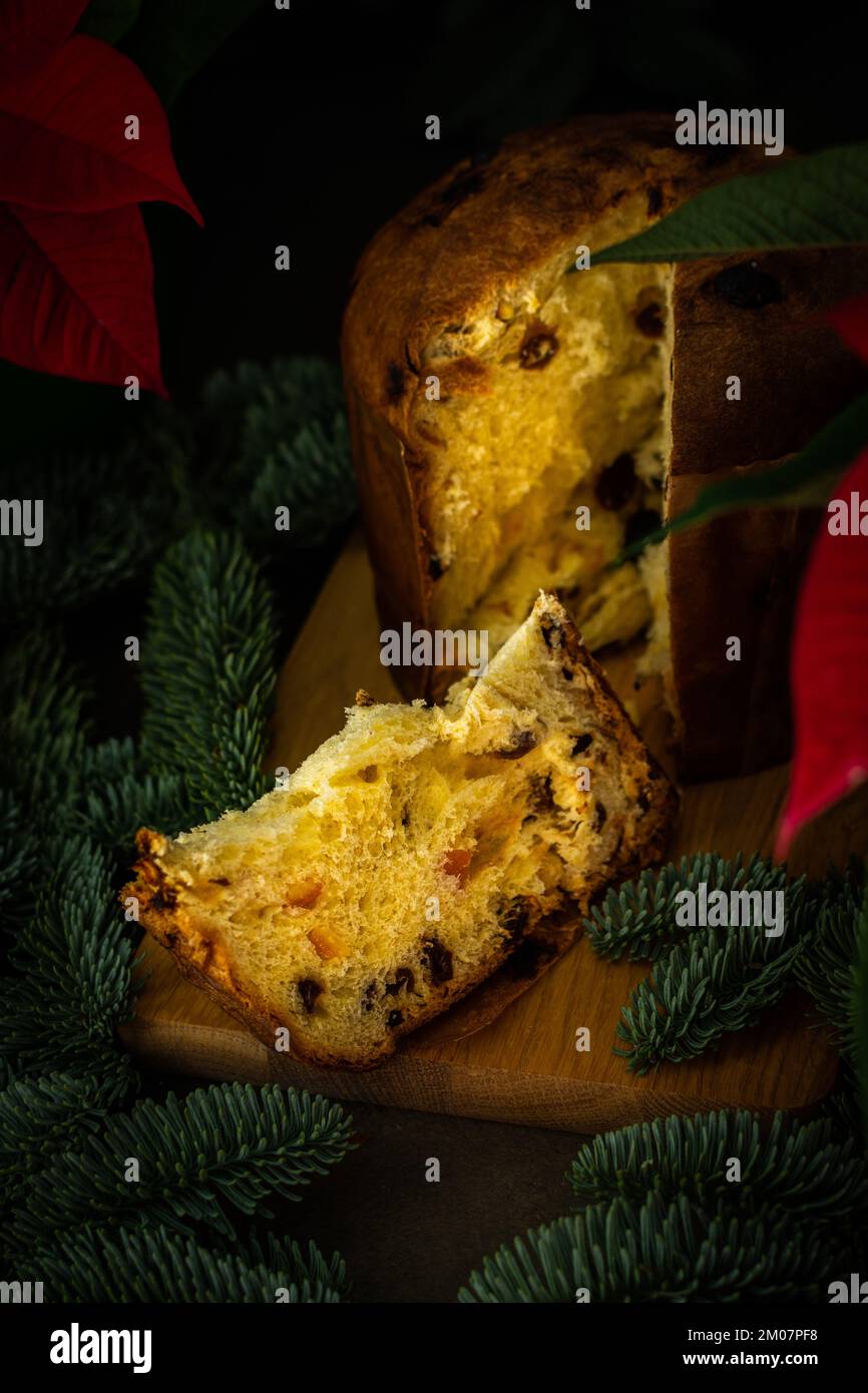 Christmas cake among green fir branches on the festive table ...